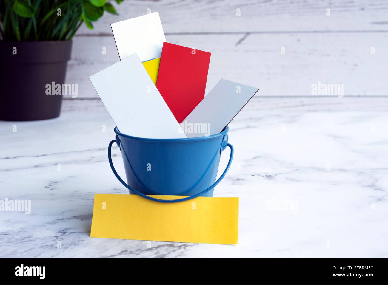 Colorful paper inside of a blue bucket with copy space. Bucket list ...