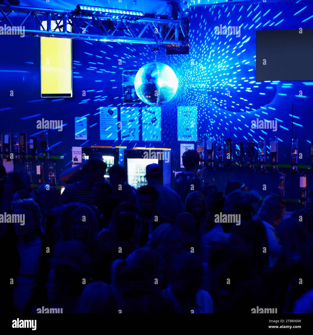 People, crowd and dancing in nightclub or party with lightning, disco ...