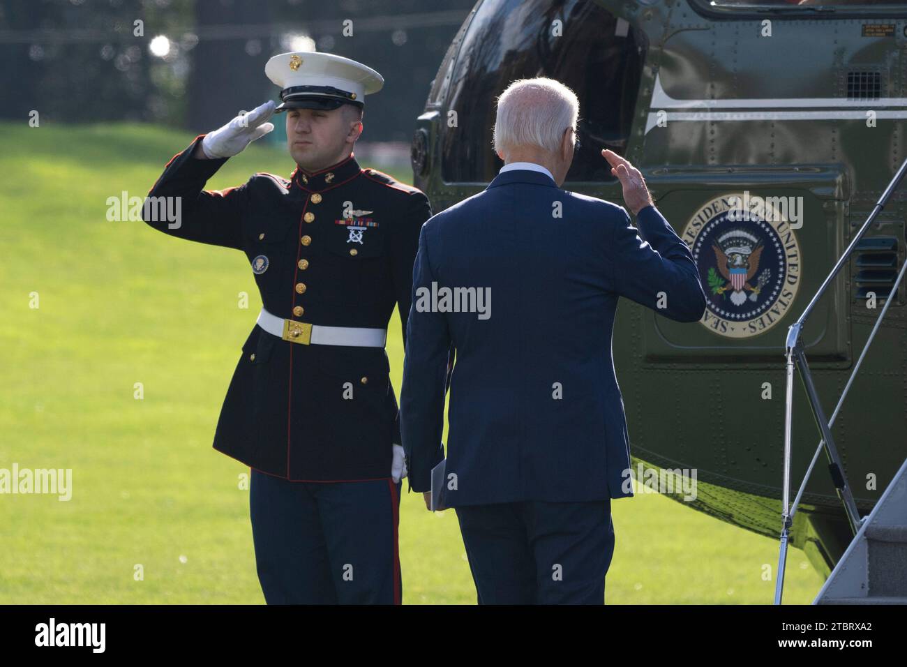 United States President Joe Biden salutes the Marine Guard as he ...