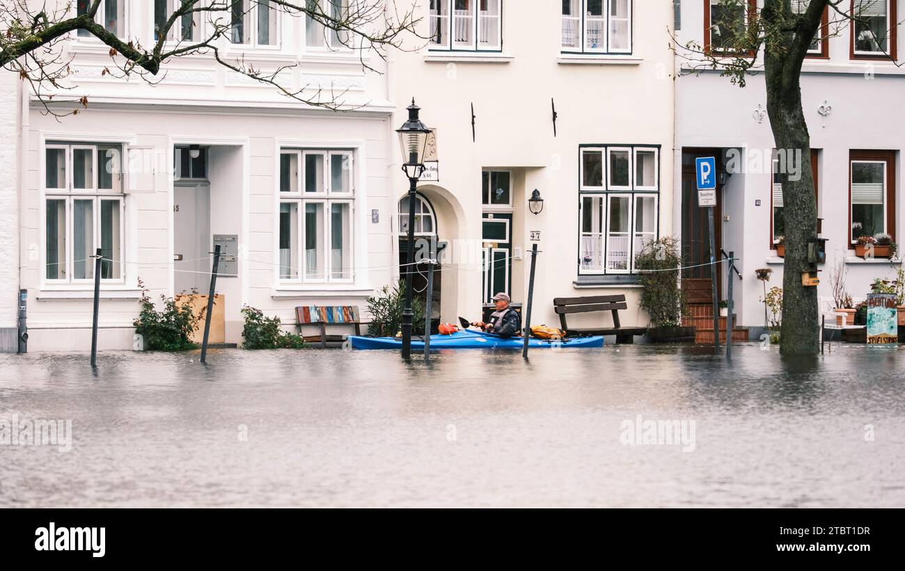 Flood in Lübeck, man in a boat Stock Photo - Alamy