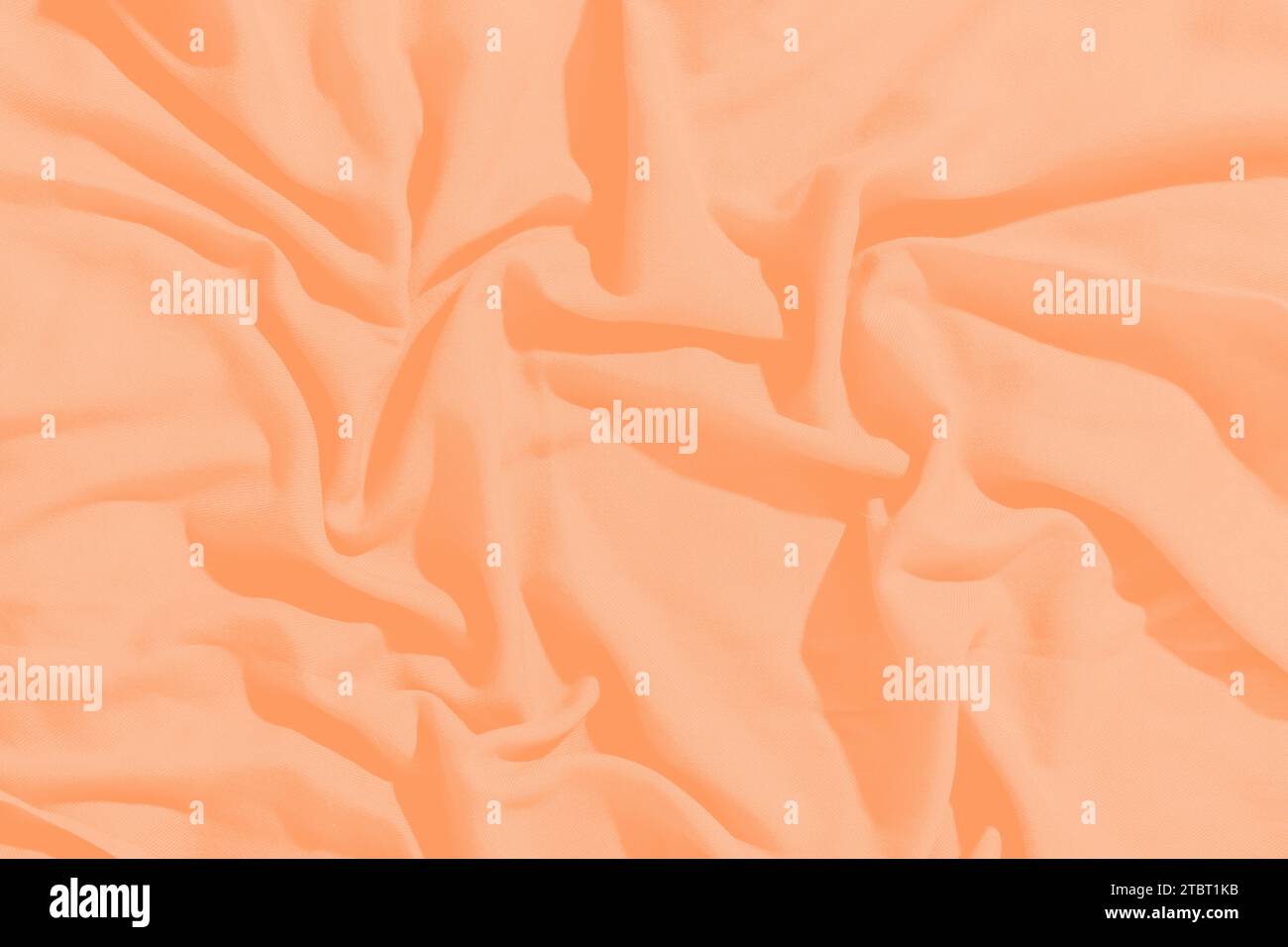 Crumpled fabric of a peach color as a background Stock Photo - Alamy