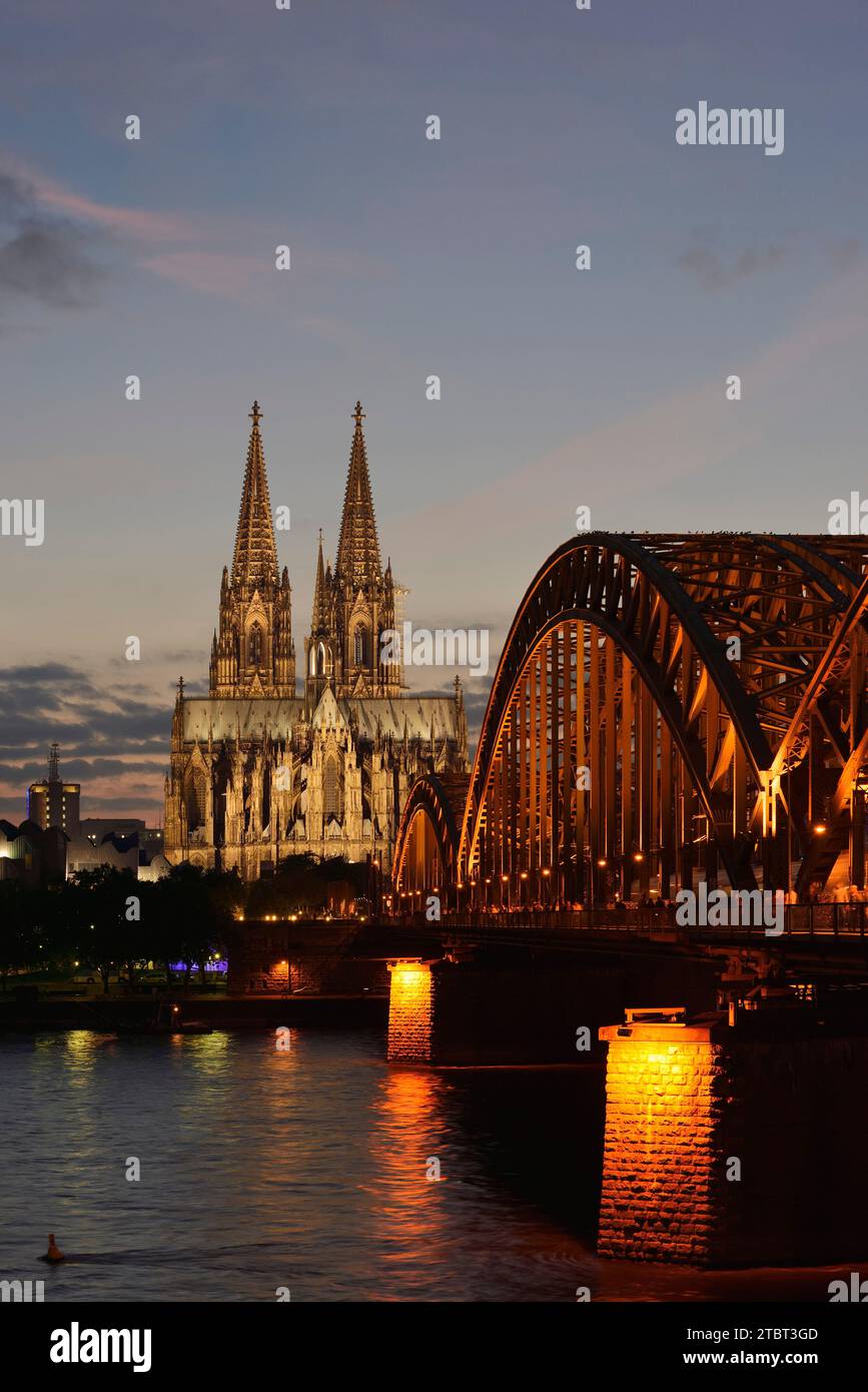 Cologne cathedral and hohenzollern bridge in the evening hi-res stock ...
