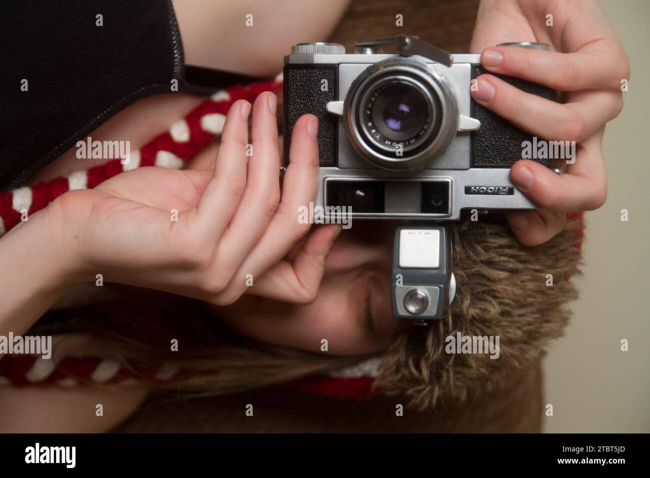 Young Woman holding Camera Sideways in Fun Photographer Pose with ...