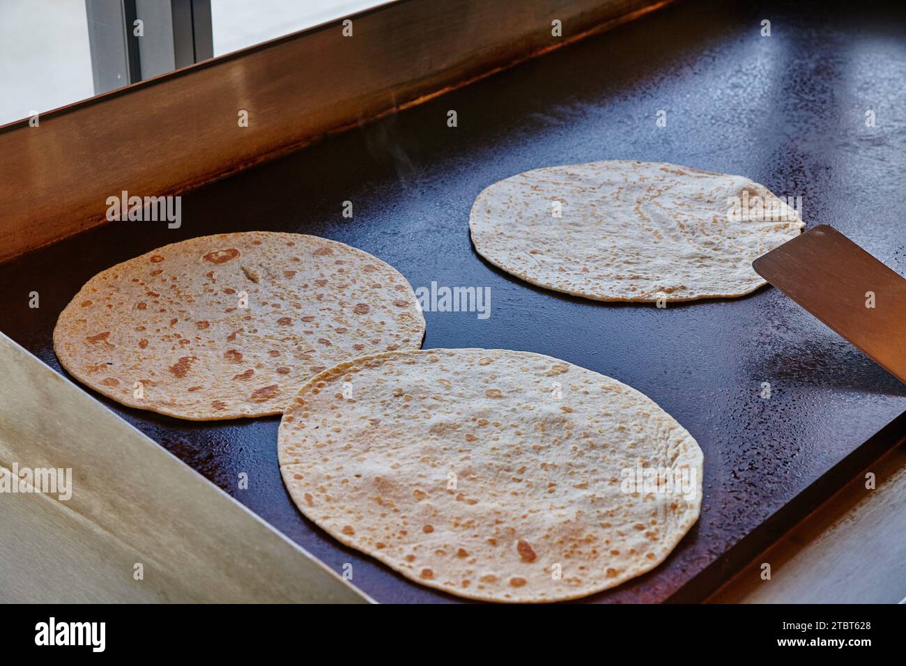 Traditional Flour Tortillas Cooking on Seasoned Griddle in Taqueria ...