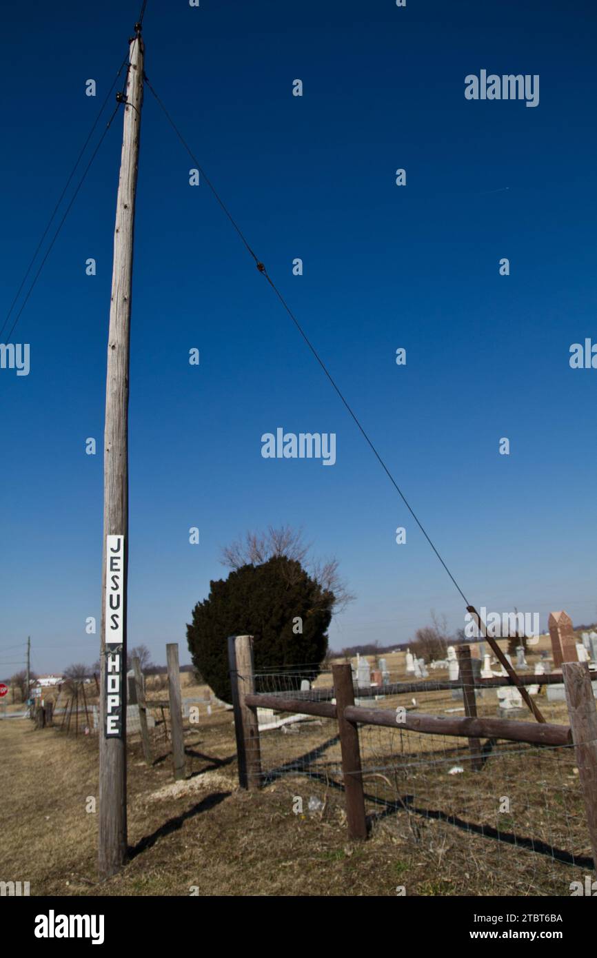 Rural Spirituality - Jesus Hope Signs on Utility Pole against Cemetery ...