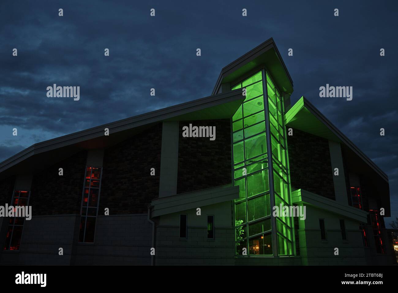 Modern Green-lit Church at Twilight with Red Accents Stock Photo - Alamy