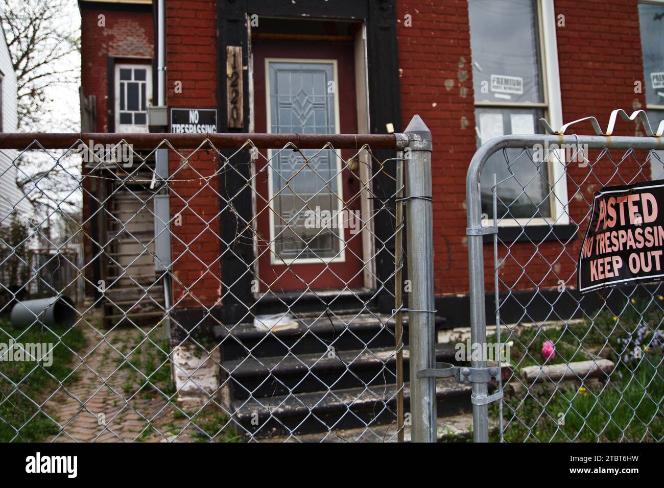 Abandoned Red Brick House Behind No Trespassing Chain Link Fence Stock ...