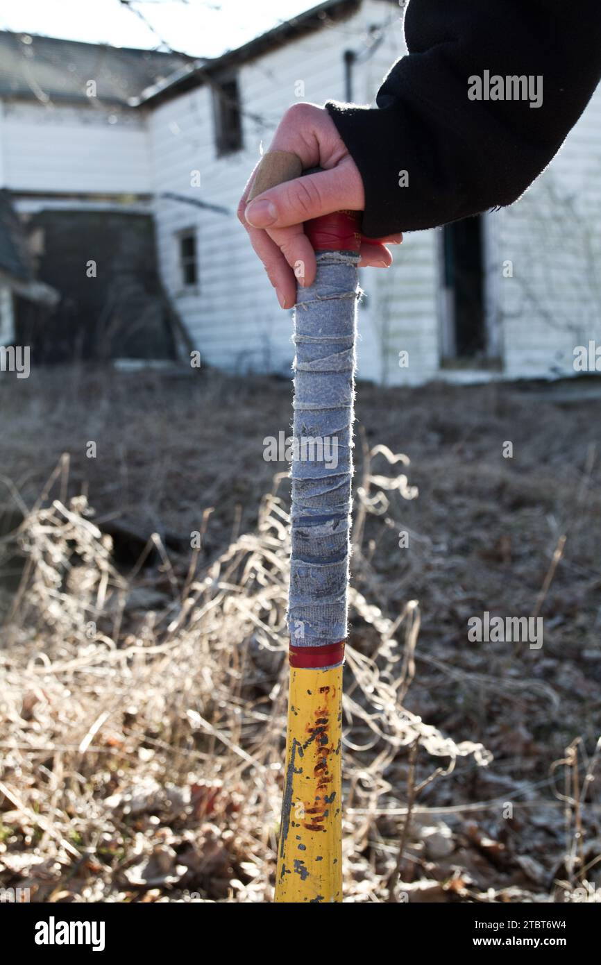 Close Up of Hand Gripping Worn Baseball Bat with Abandoned House ...