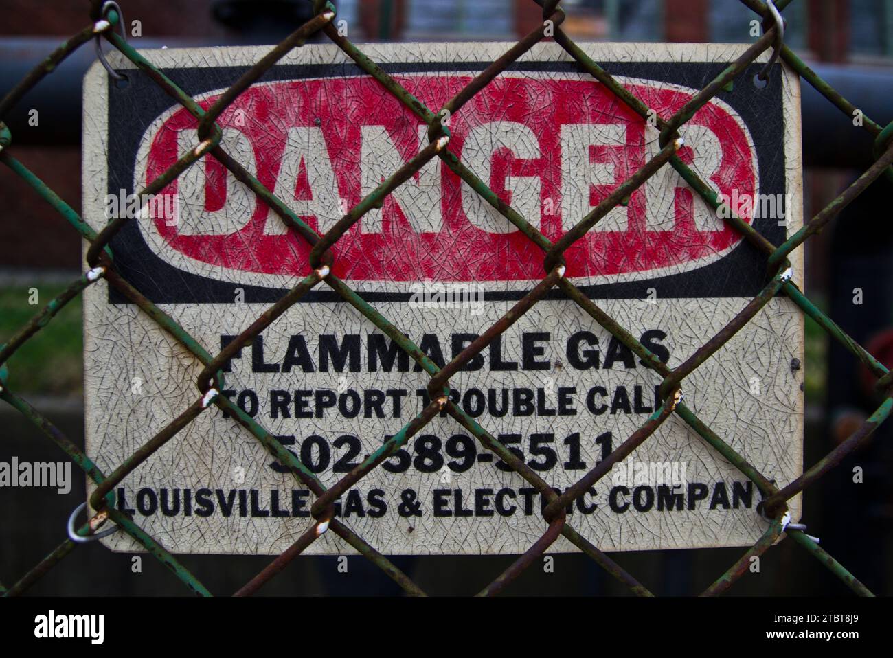 Worn Danger Sign Behind Chain-link Fence Warning of Flammable Gas Stock ...
