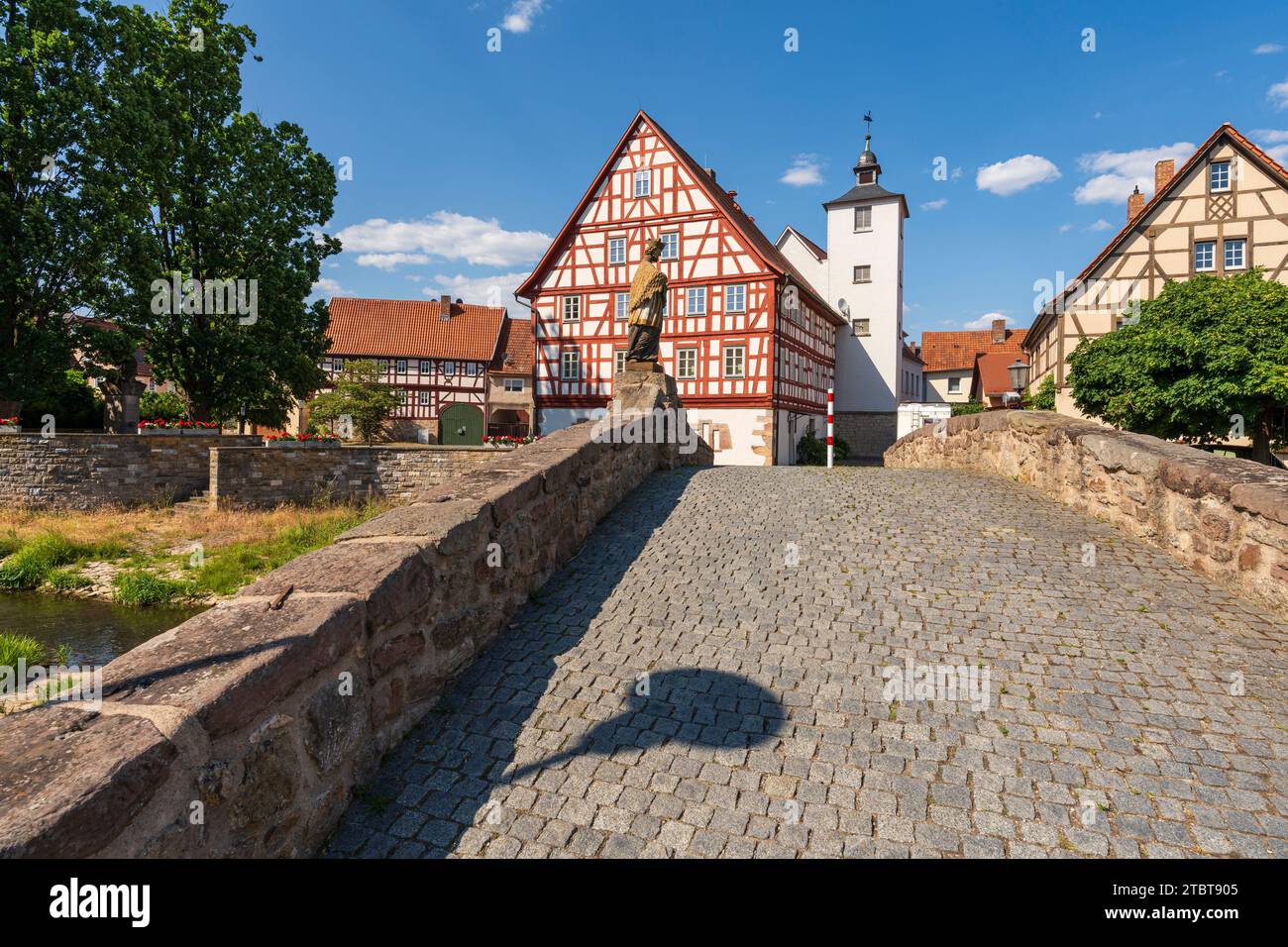 The Johannisbrücke bridge over the Streu river and the town hall in ...
