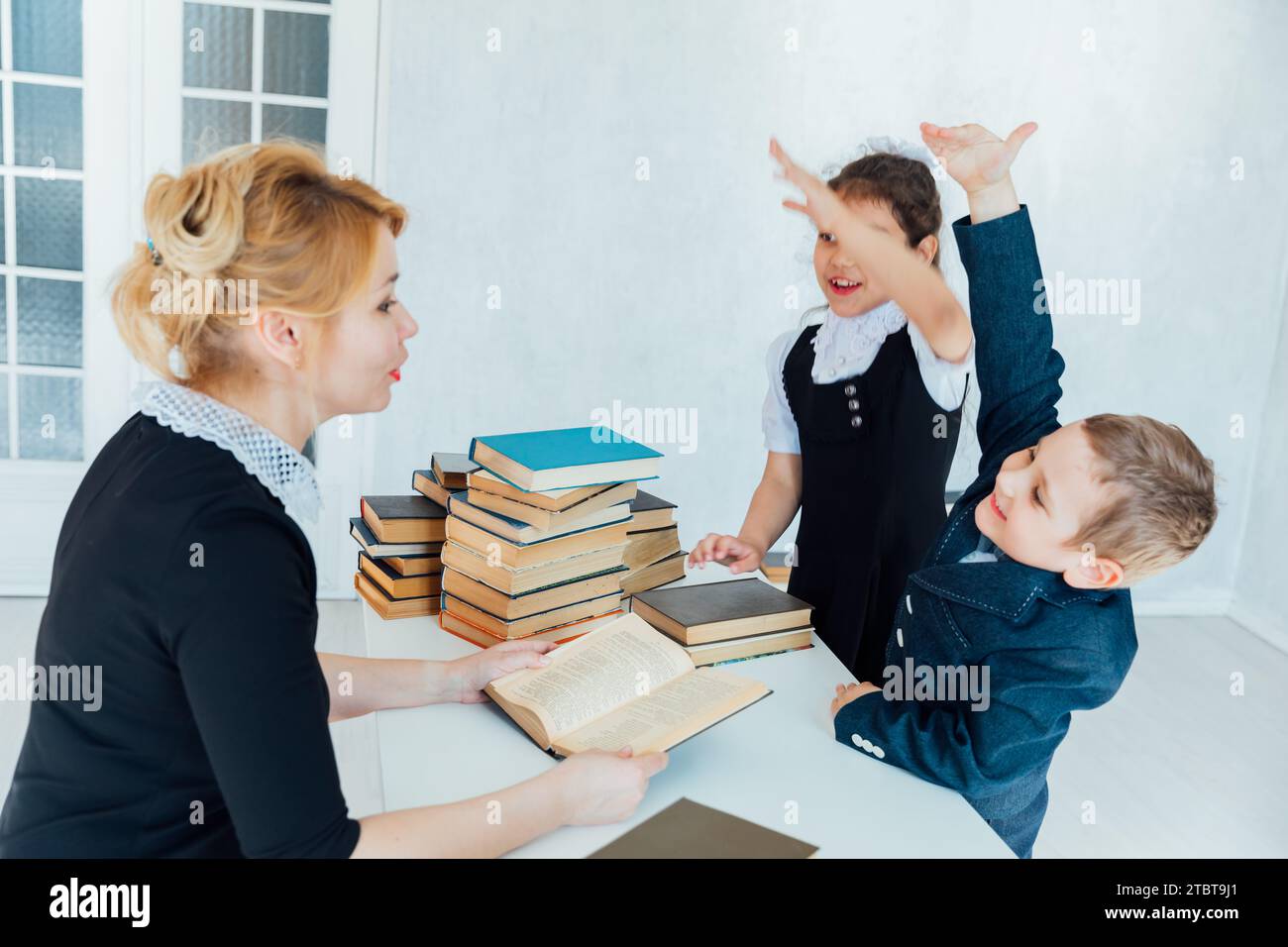 Teacher teaching children in school Stock Photo - Alamy