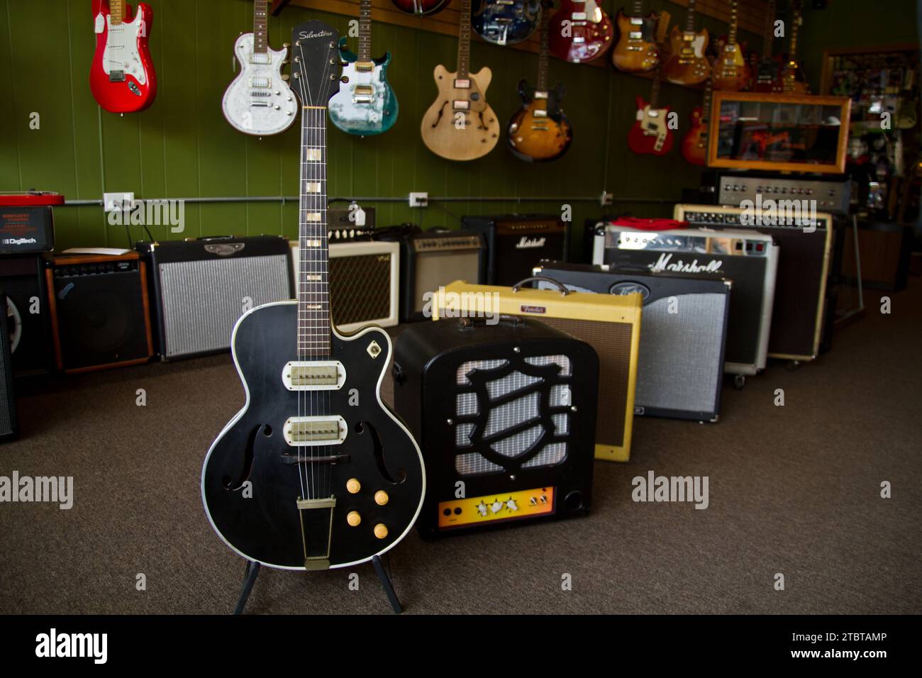 Music Store Interior with Focus on Black Electric Guitar and Amplifiers ...