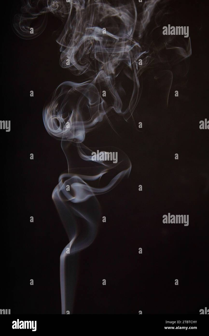 Ethereal Dance of Incense Smoke on Dark Background Stock Photo - Alamy