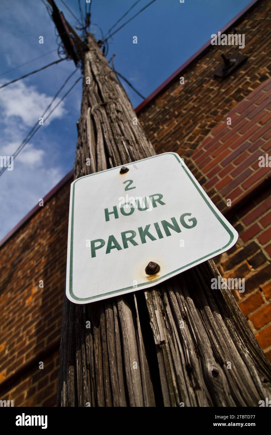 Weathered Parking Sign on Utility Pole against Red Brick in Urban ...