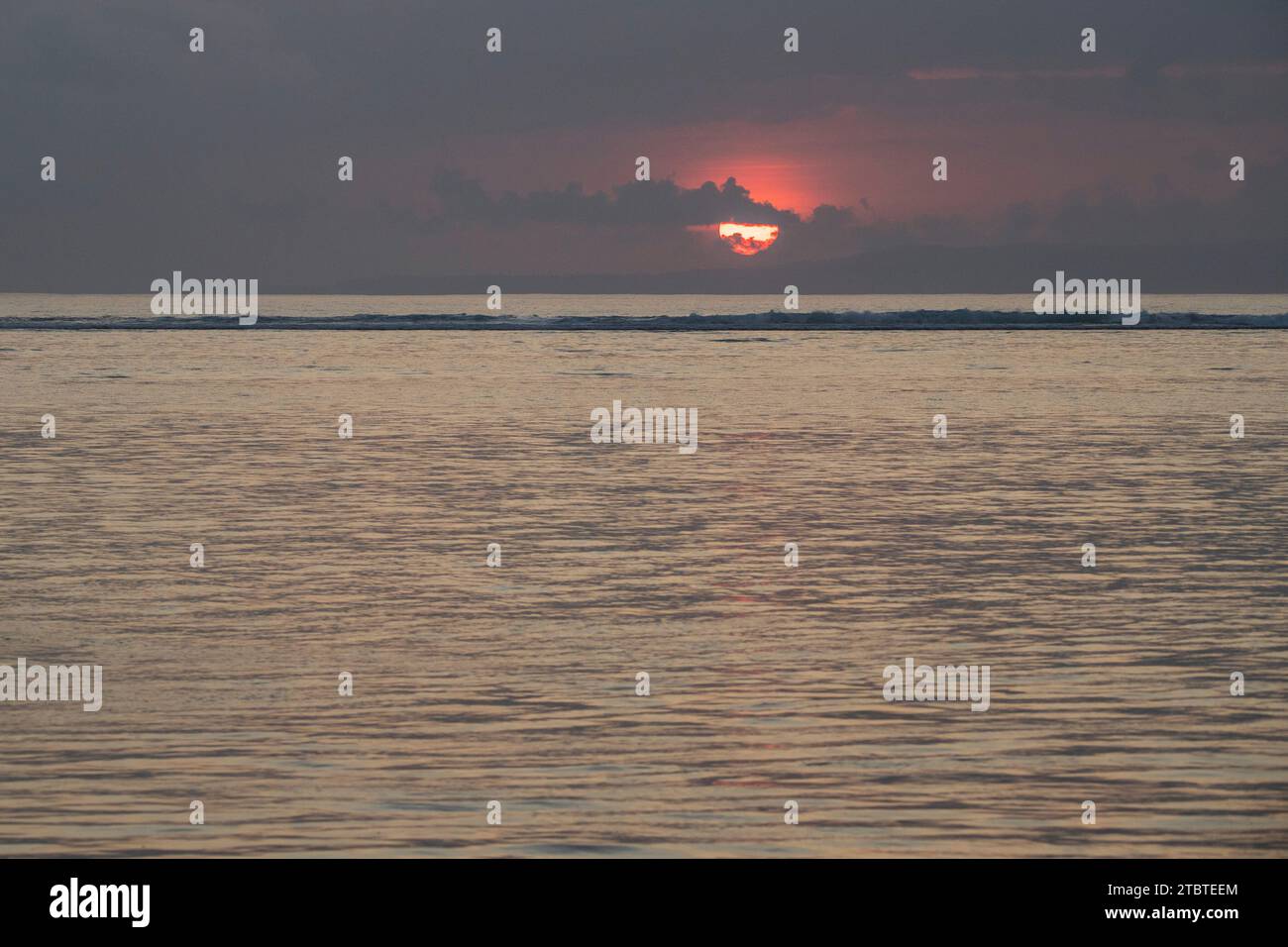 Sunrise on sandy beach with small temples in the water, landscape shot ...