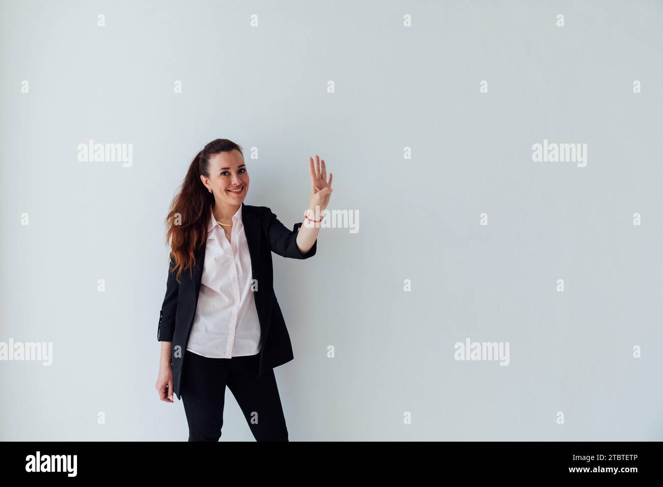 brunette woman shows four thumbs up Stock Photo - Alamy