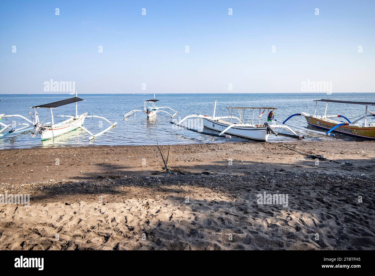 Jukung on the beach by the sea, traditional fishing boat in the morning ...