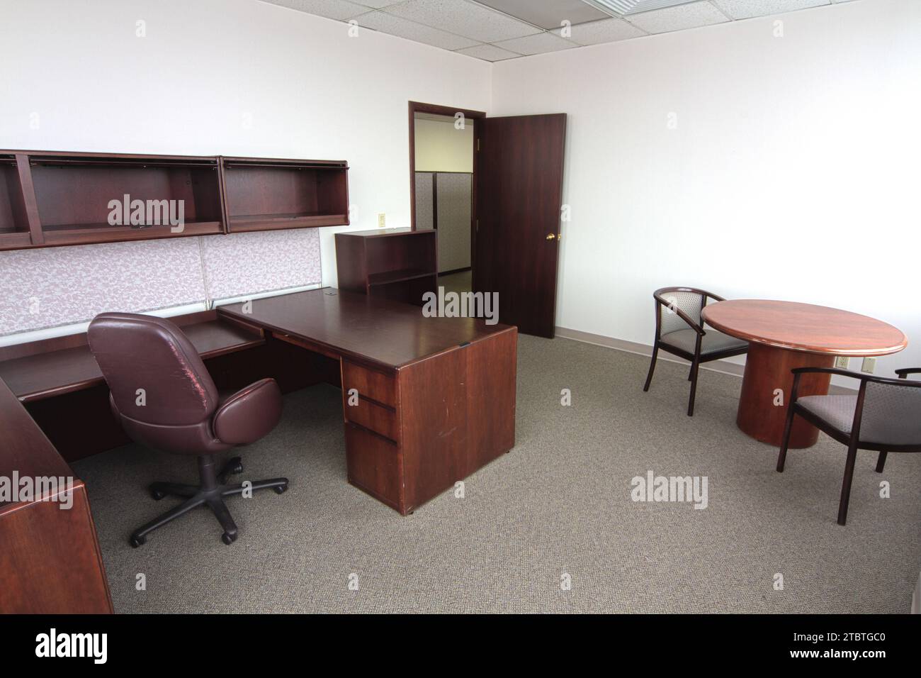 Traditional Empty Office Space with L-Shaped Desk and Meeting Table ...