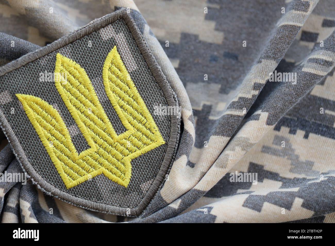 Symbol of Ukrainian army on the camouflage uniform of a Ukrainian ...