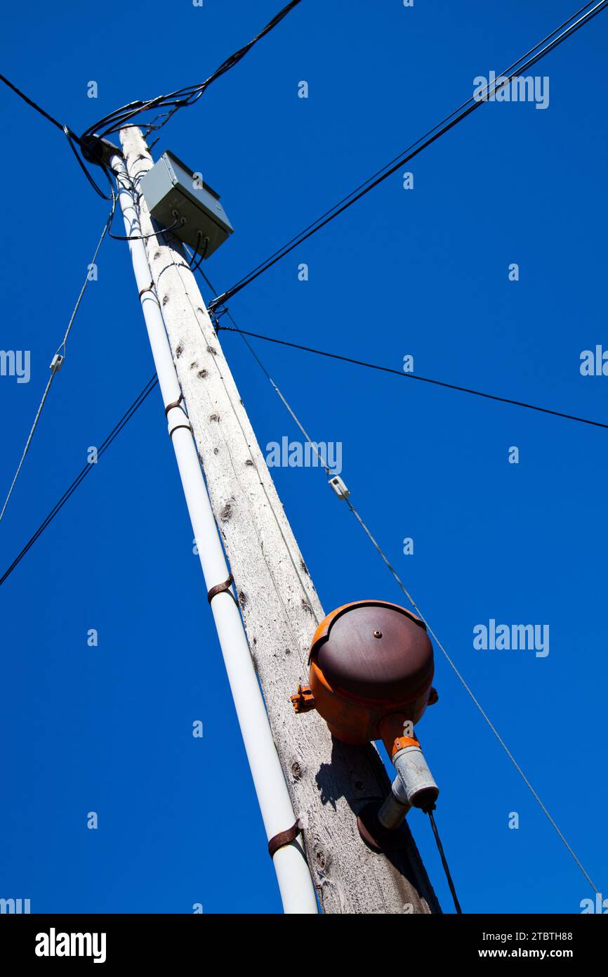 Low Angle View of Weathered Utility Pole Against Blue Sky in Urban ...