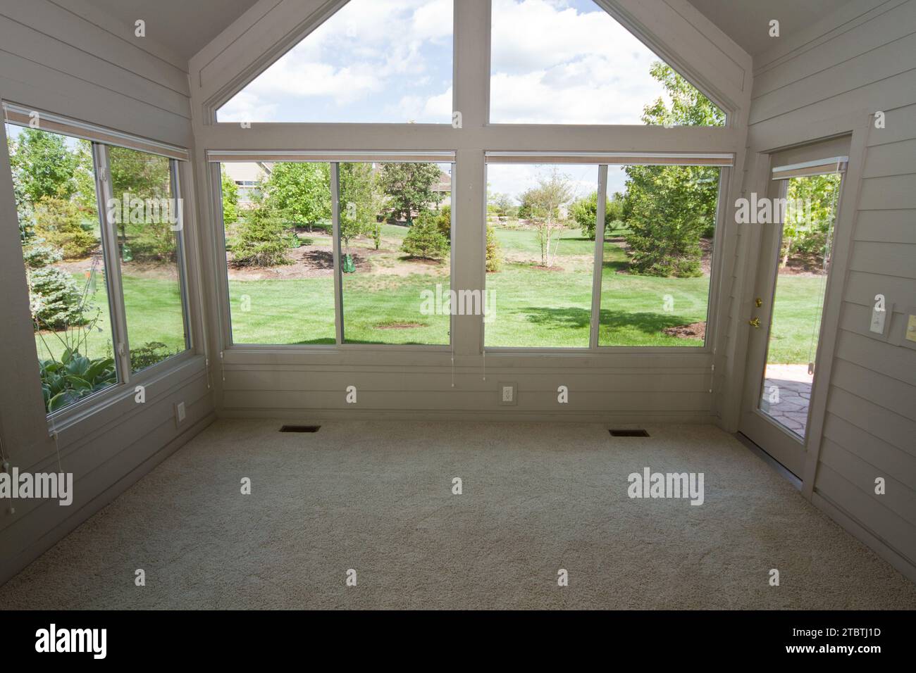 Three Season Room with Large Window Overlooking Lush Backyard in Fort ...