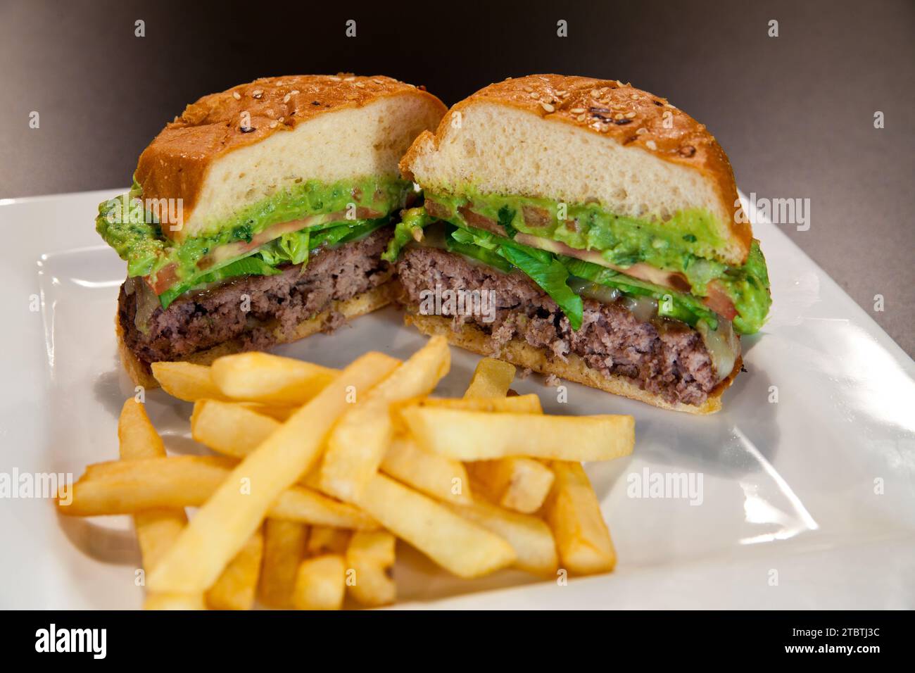 Classic American Cheeseburger and Fries on White Plate, Eye-level ...