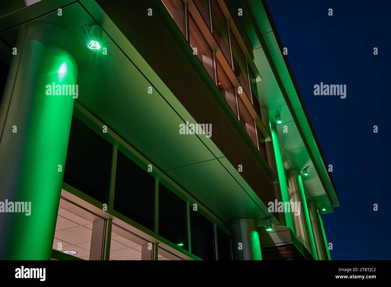 Green Illuminated Modern Building in Night Time Urban Landscape Stock ...