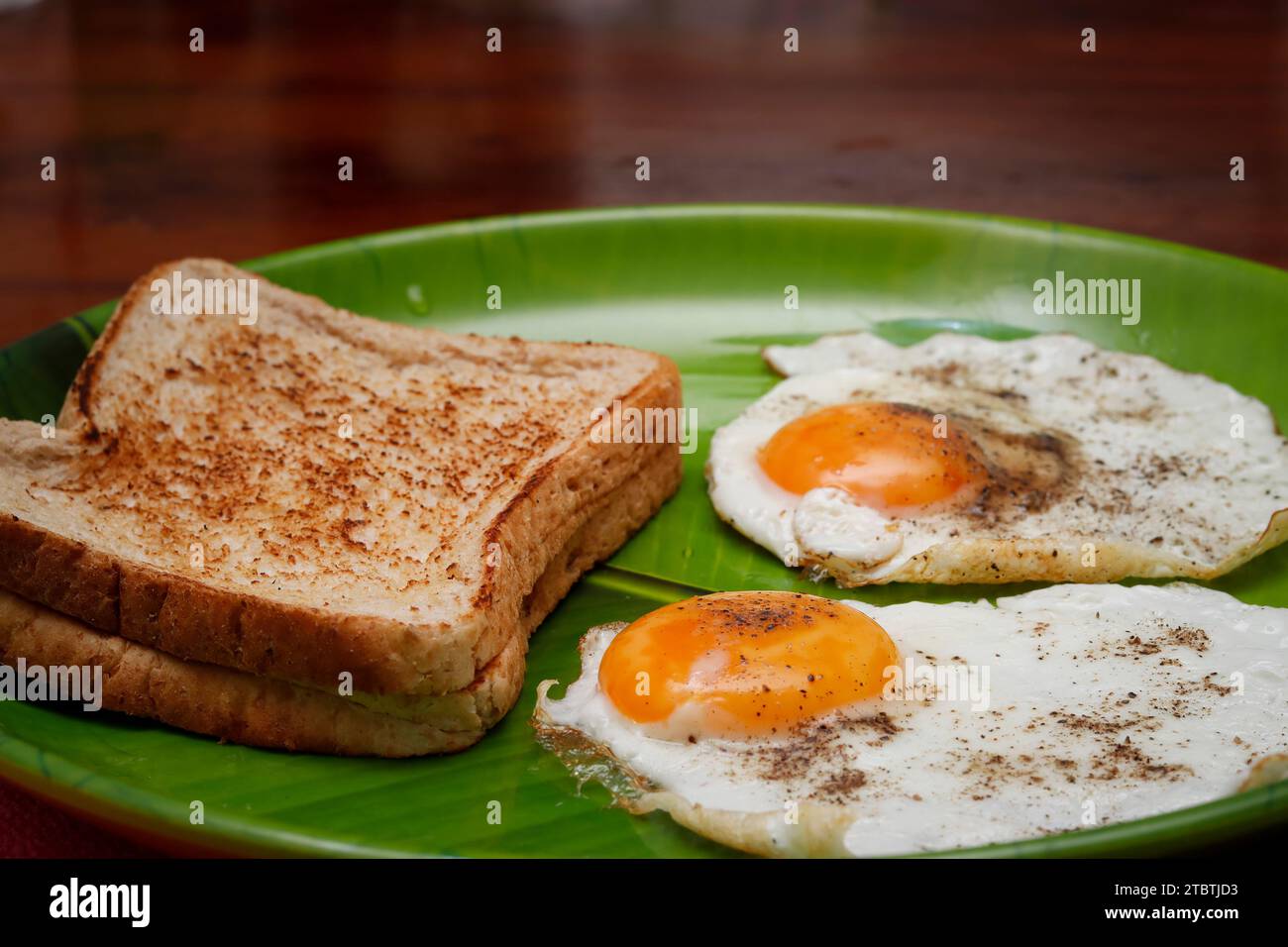 Closeup Image Of Toasted Bread And Sunny Side Up Eggs In Green Plate ...