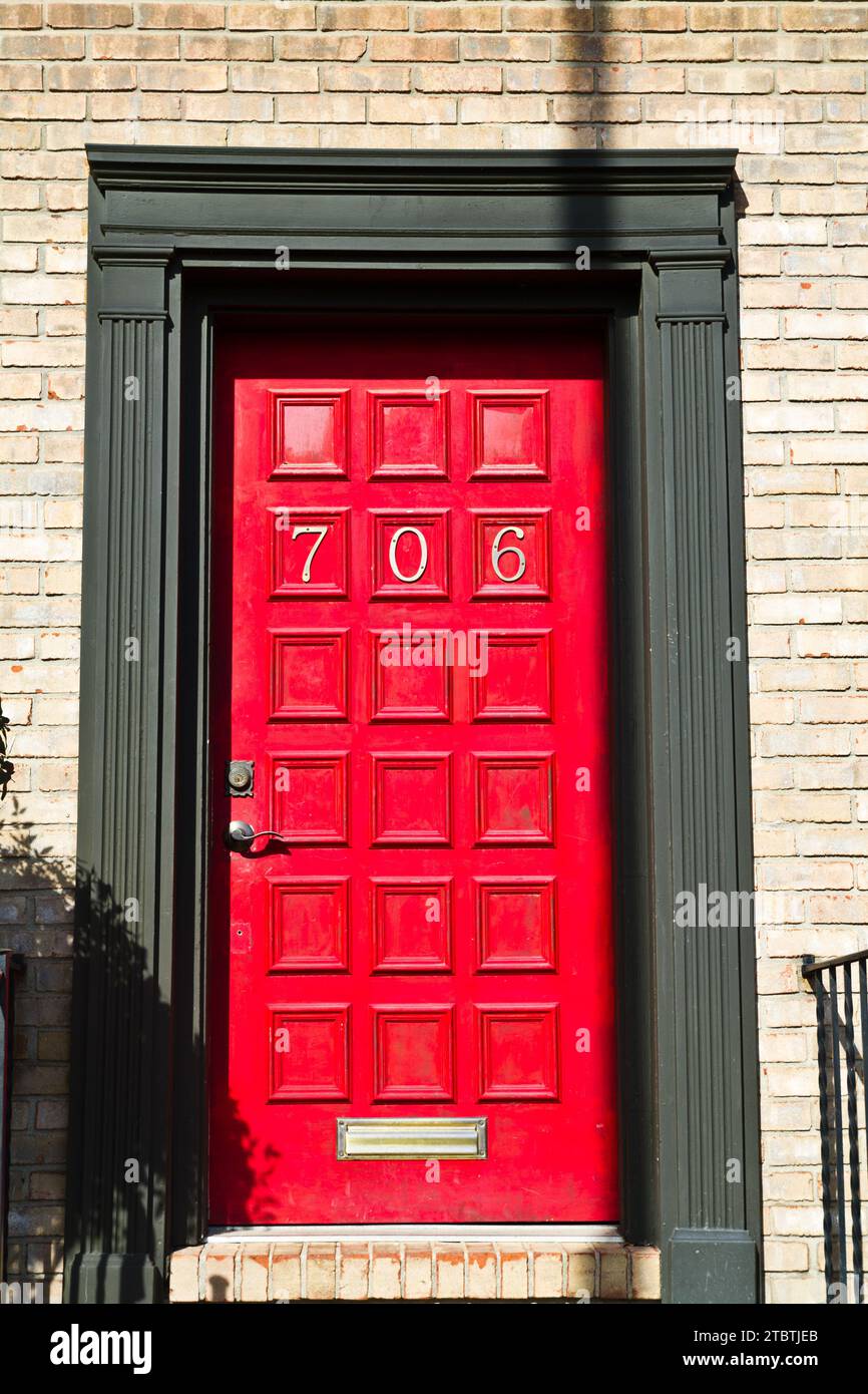 Metallic Number on Vibrant Red Door with Brick Wall in Daylight Stock ...