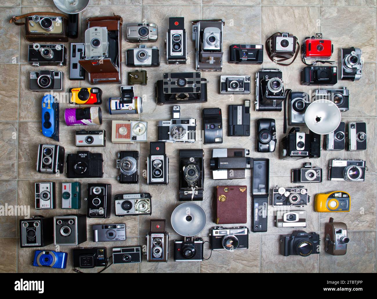 Eclectic Camera Collection Displayed on Tile Floor Stock Photo - Alamy