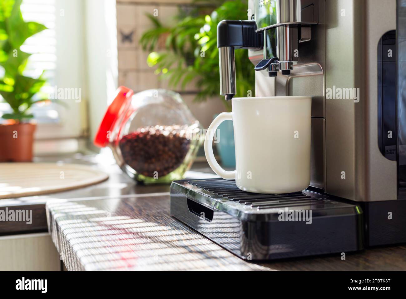 Modern electric coffee machine with cup on countertop in kitchen Stock ...