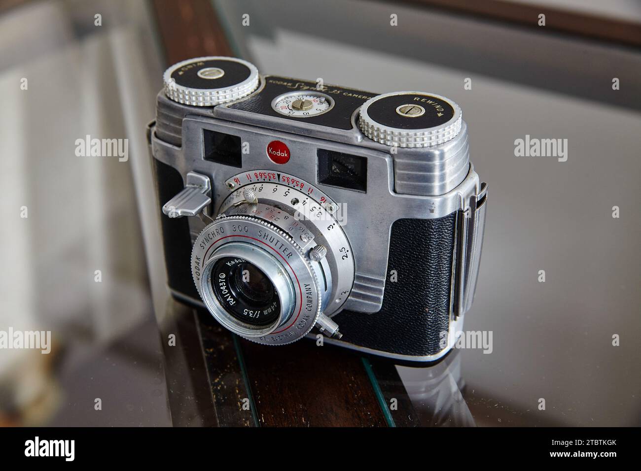 Vintage Kodak Film Camera on Reflective Surface in Soft Natural Light ...