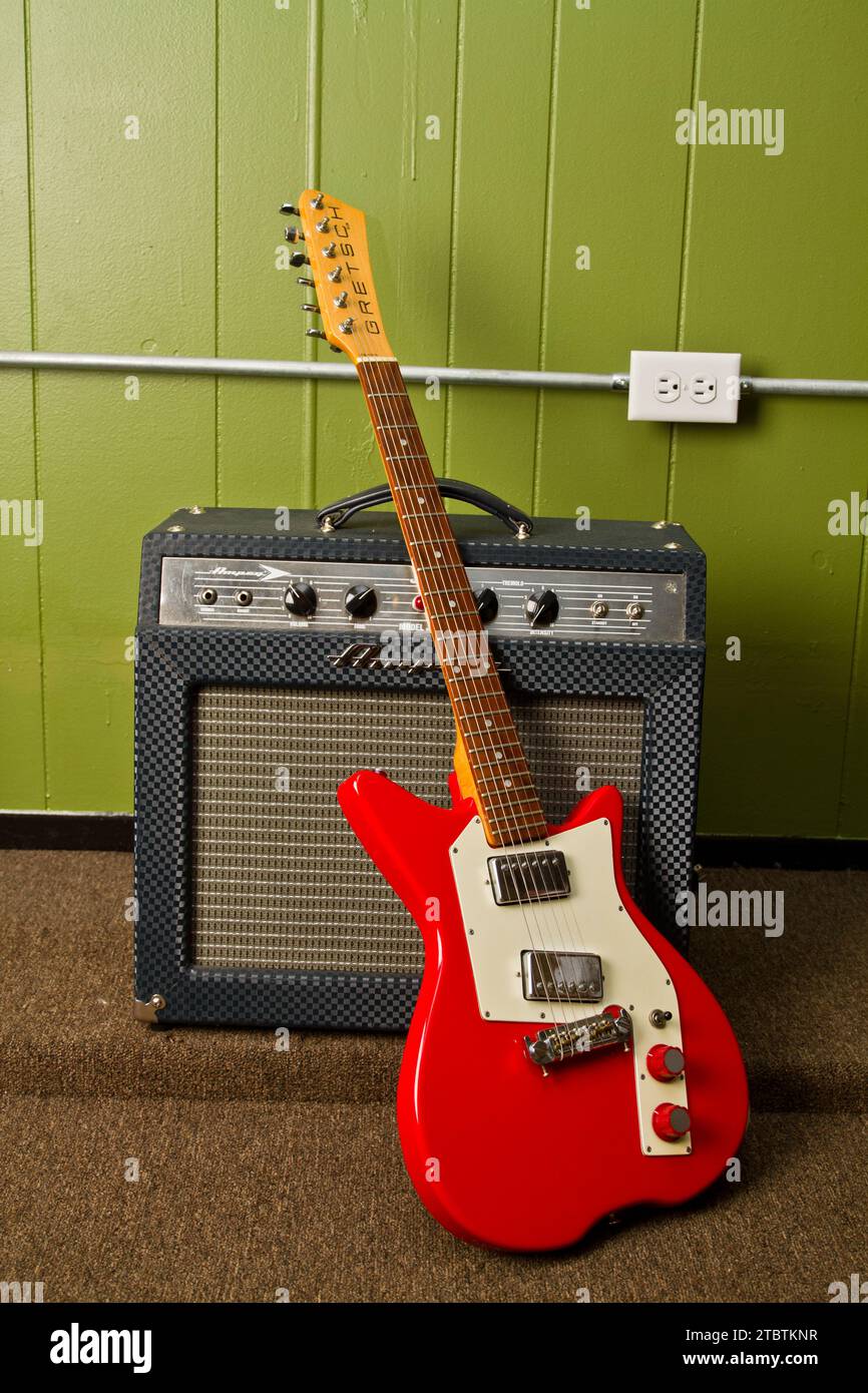 Red Electric Guitar and Vintage Amplifier in Casual Indoor Setting ...