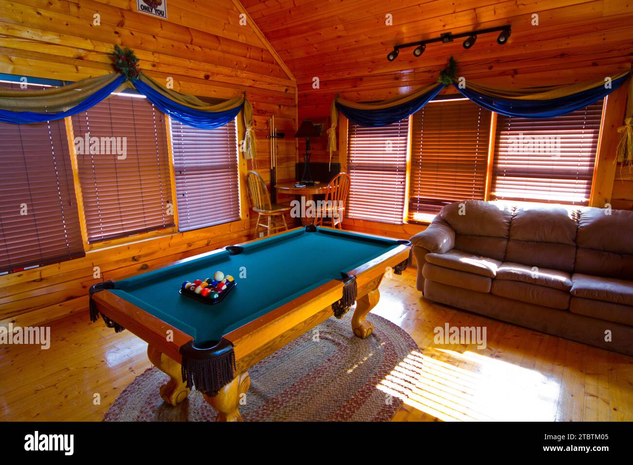 Cozy Rustic Cabin Interior with Pool Table and Leather Sofa in ...