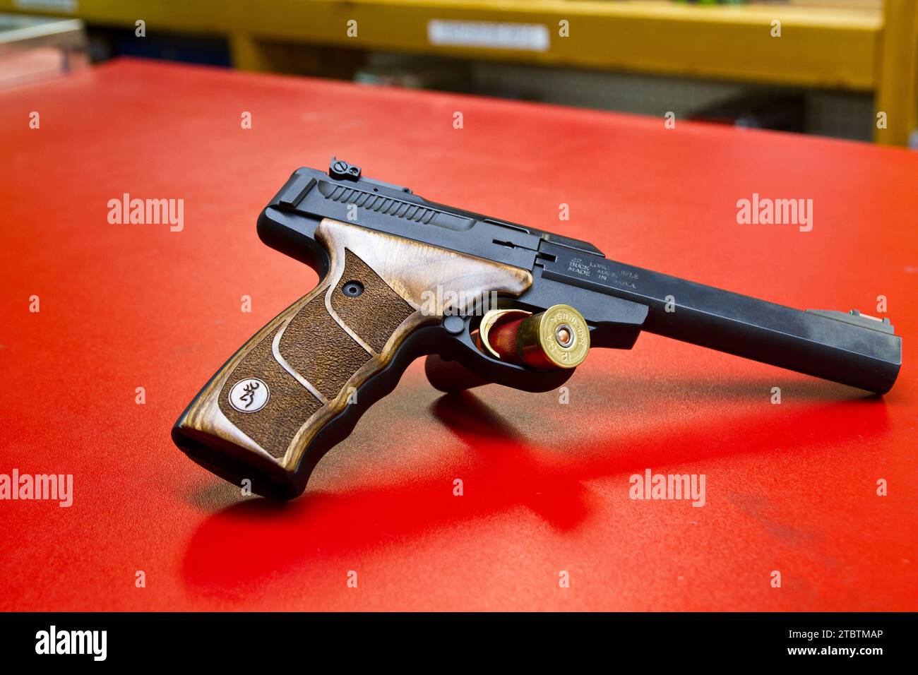 Semi-Automatic Pistol and Bullet on Red Surface in Detailed Profile ...