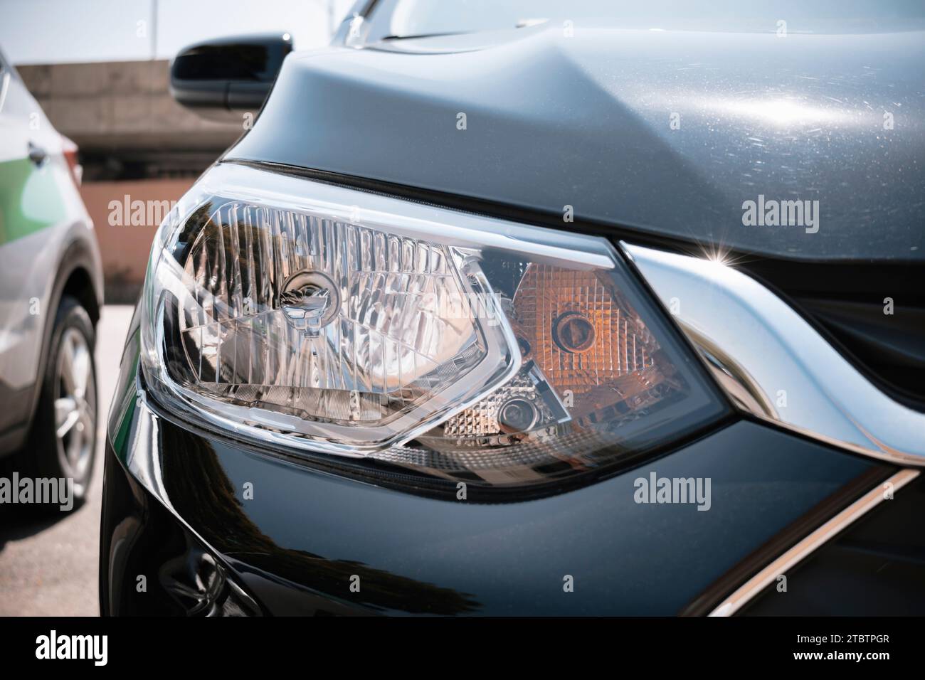 A close up image of a modern frontal car's headlight. Modern lines ...