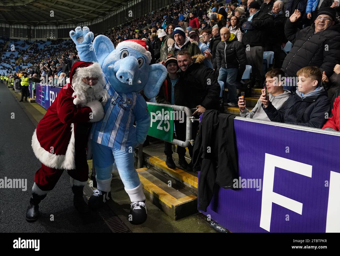 Coventry City club mascot Sky Blue Sam poses with Santa Claus at half ...