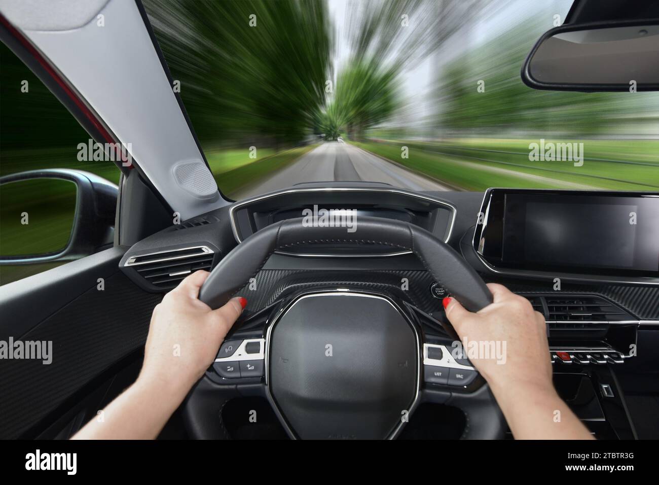 Woman driving a car fast Stock Photo - Alamy