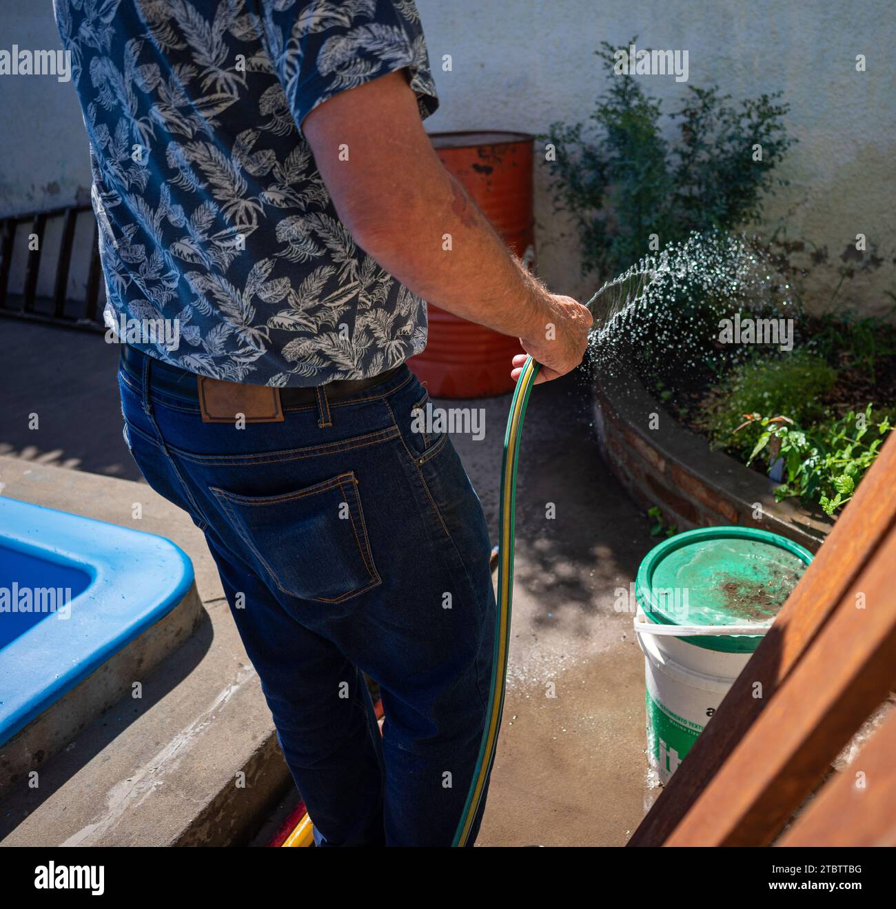 Person watering the lawn with hose hi-res stock photography and images ...
