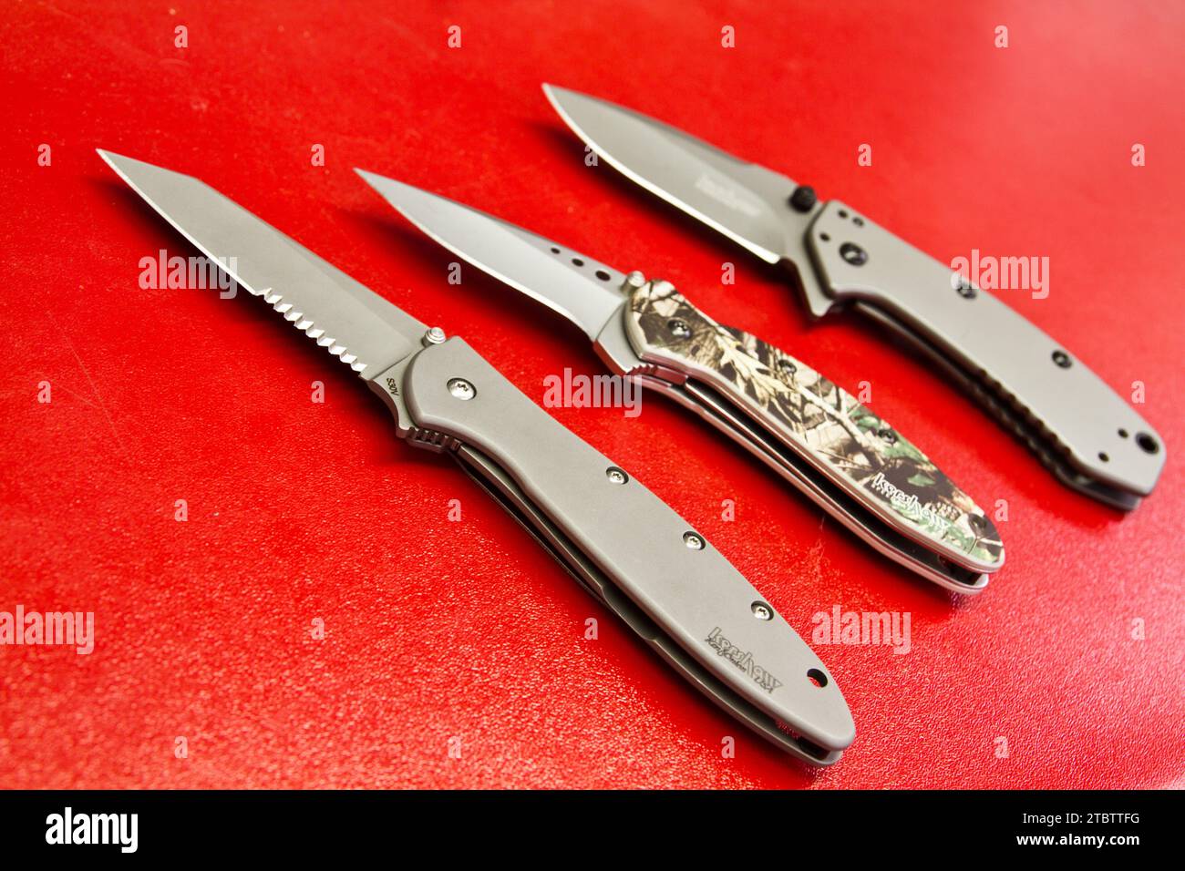 Assortment of Folding Knives on Vivid Red Backdrop Stock Photo - Alamy