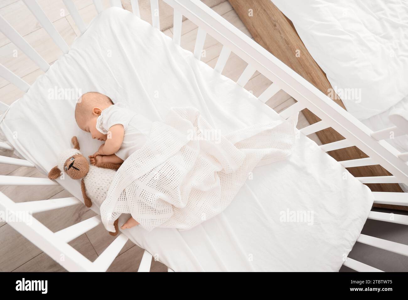 Little cute baby with toy sleeping in crib at home Stock Photo - Alamy