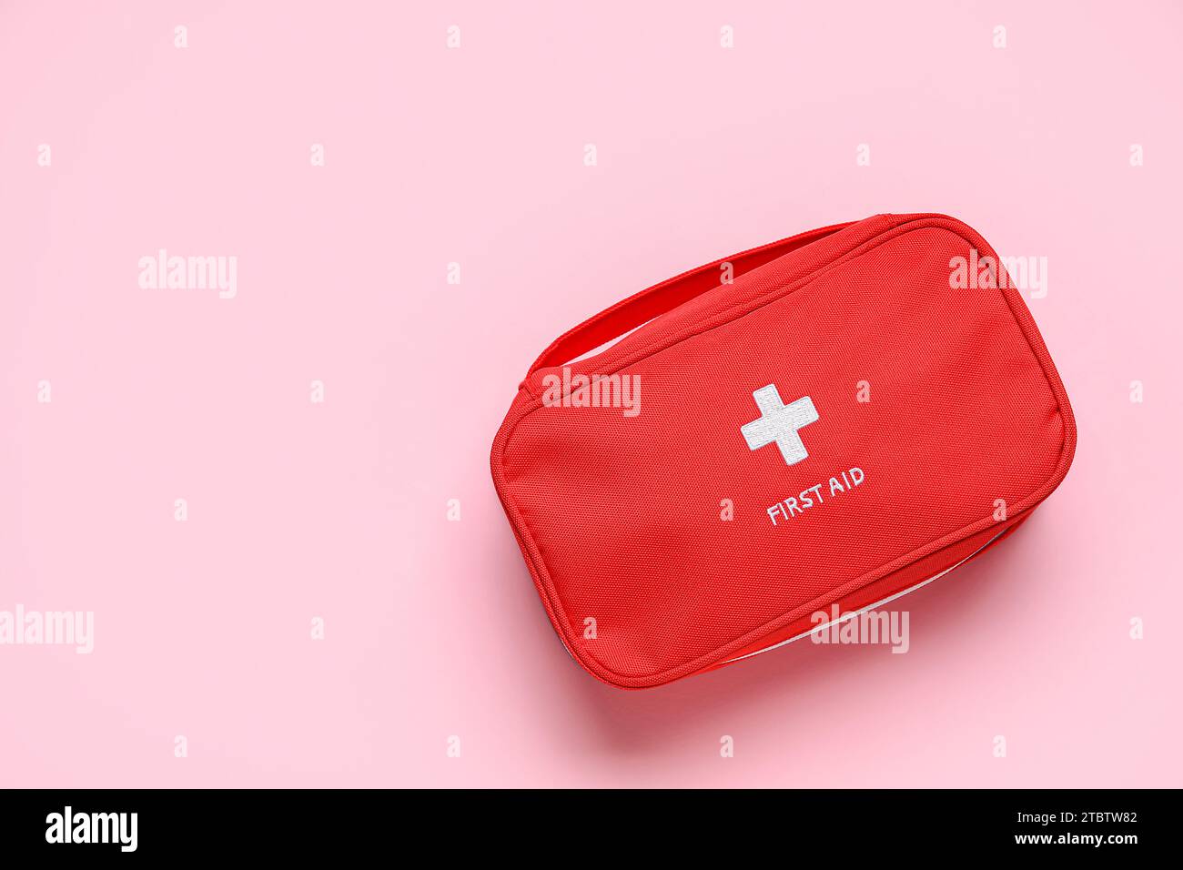First aid kit on pink background Stock Photo - Alamy