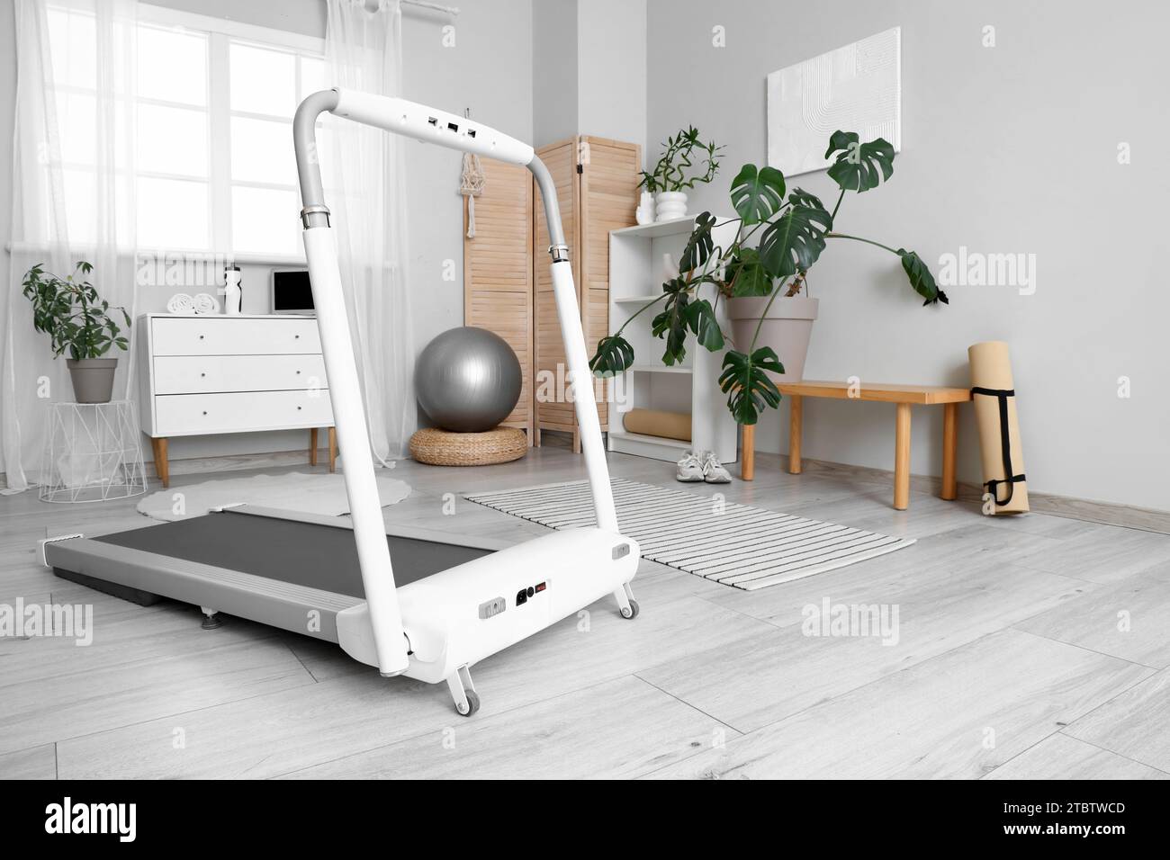 Modern treadmill in living room interior Stock Photo - Alamy