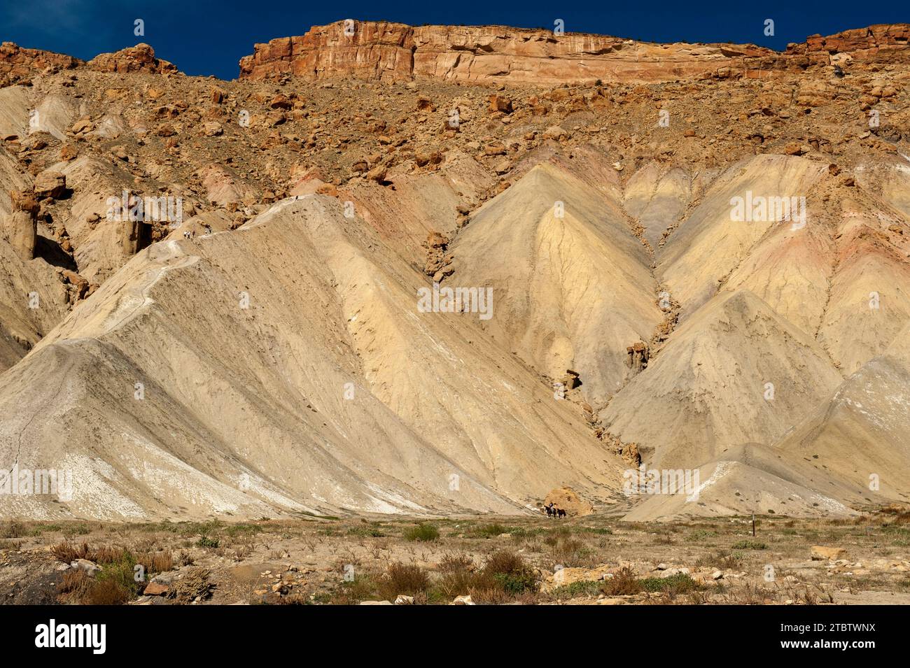 Hikers ascend the barren slopes of Colorado's Mt. Garfield, near Grand ...
