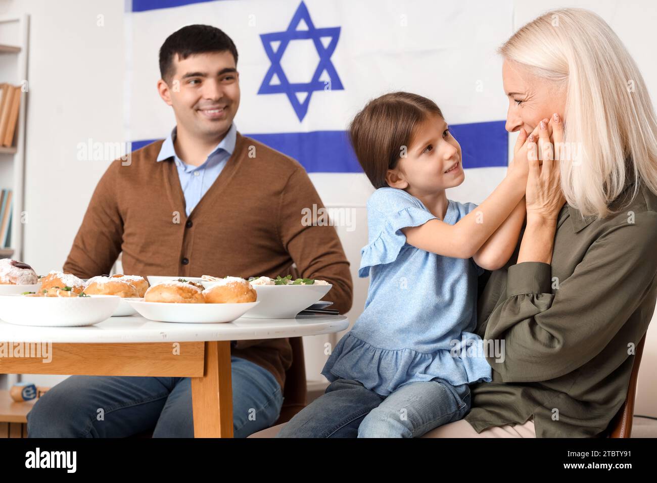 Little Jewish girl having dinner with her grandmother at home on ...