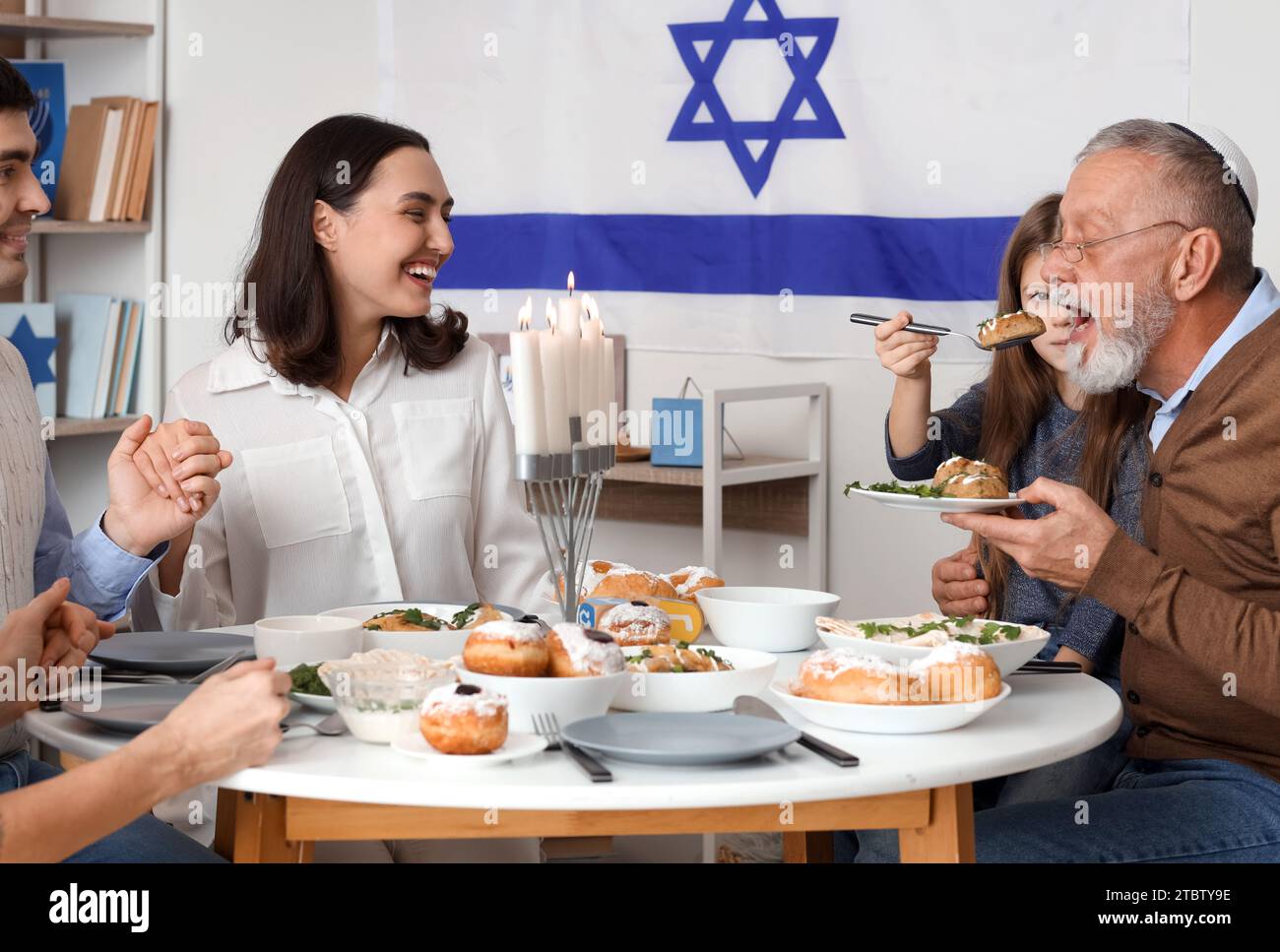 Happy Jewish family having dinner at home on Hanukkah Stock Photo - Alamy