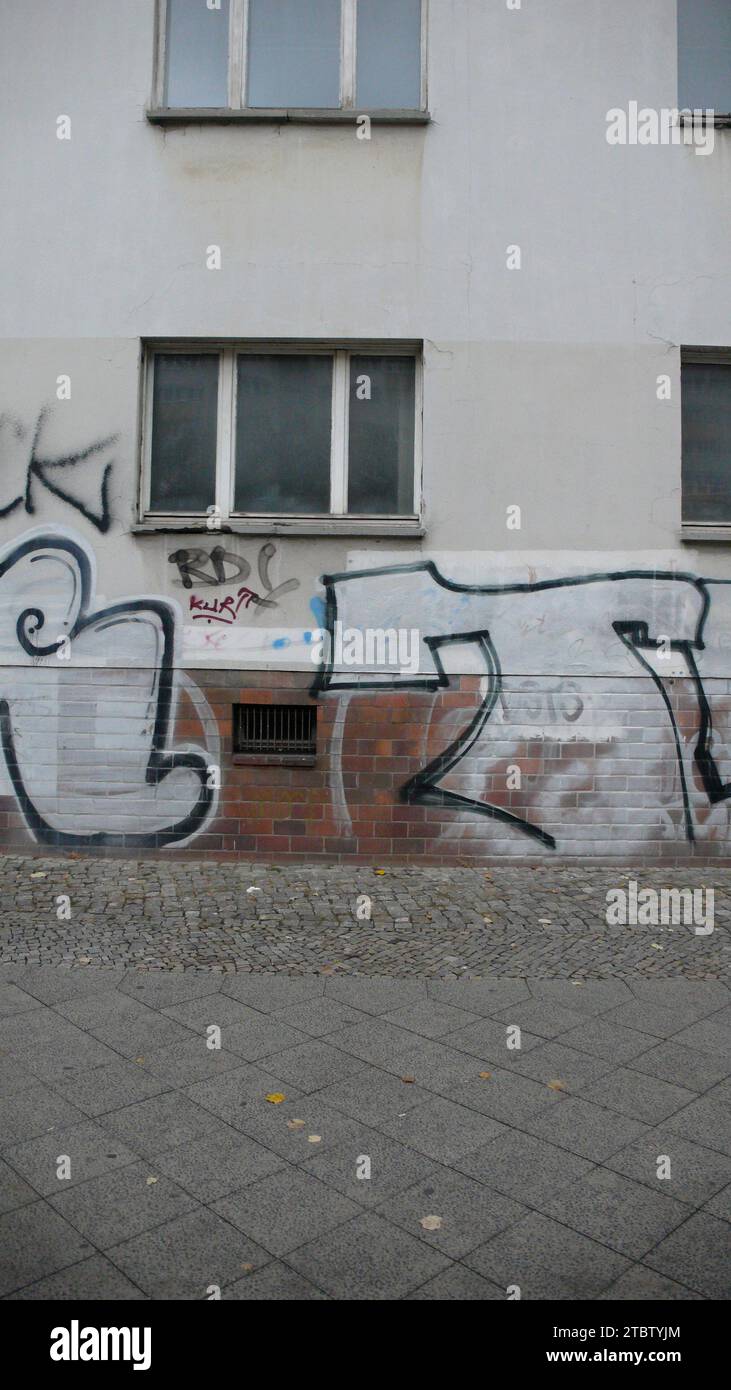 Tagging, graffiti on side of stucco building in the former East Germany ...