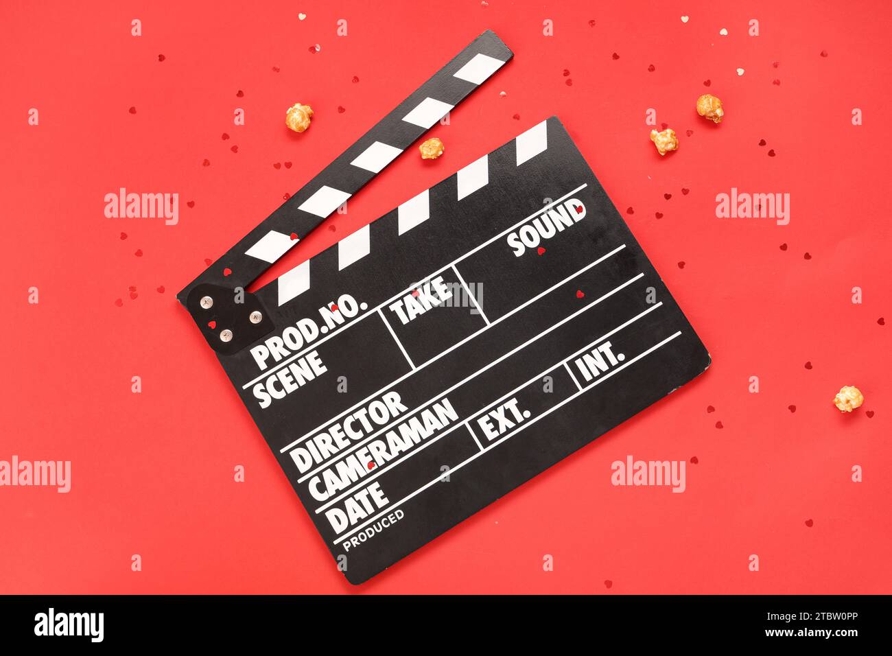 Movie clapper with popcorn and confetti on red background. Valentine's ...