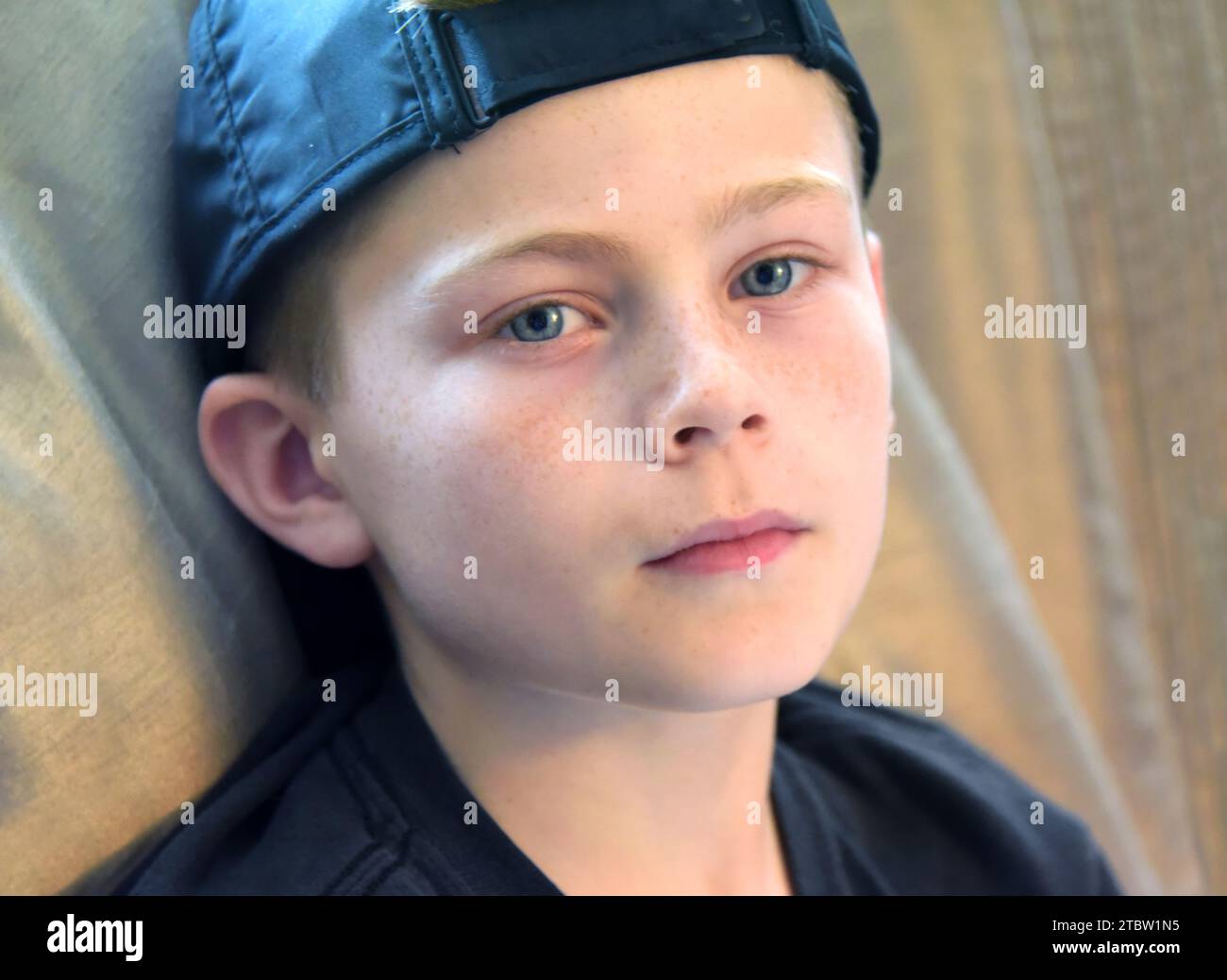 Young boy looks at the camera and his face is totally expressionless ...