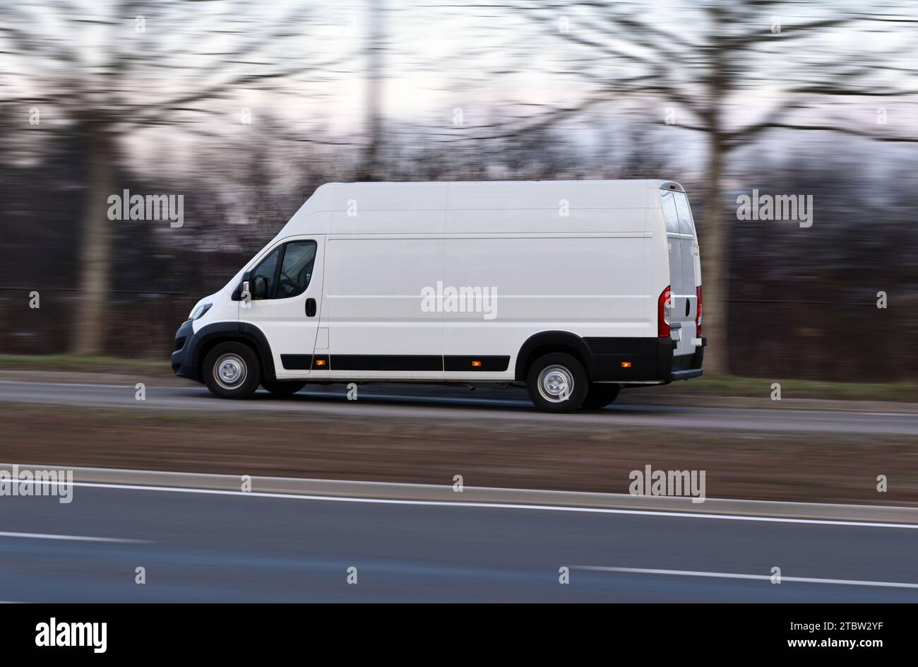 The large delivery van drives at high speed Stock Photo - Alamy
